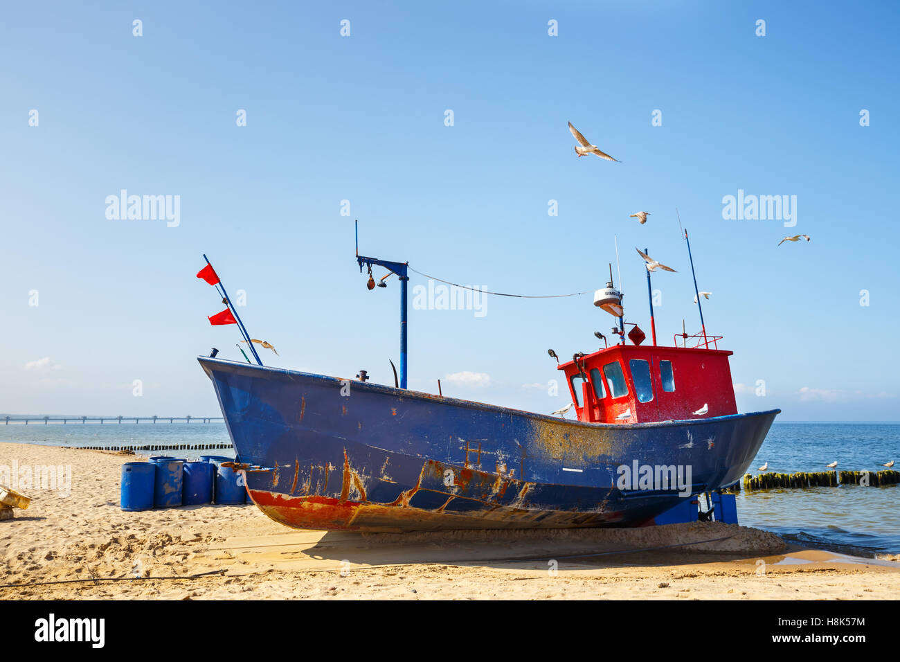 Fishing boat on the beach at summer time Stock Photo - Alamy