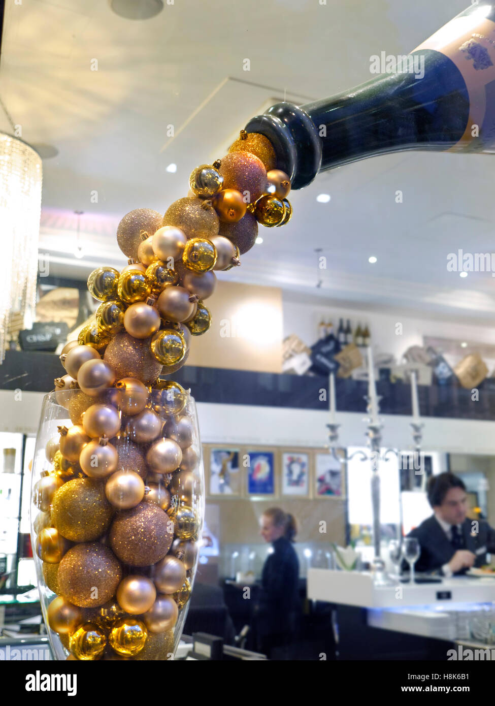 Christmas window display of baubles as bubbles pouring into champagne ...