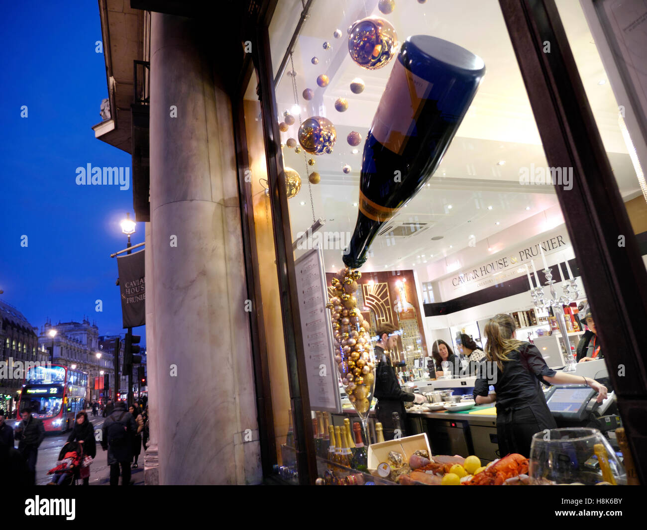 Caviar and Champagne bar window display with Piccadilly Road red bus ...