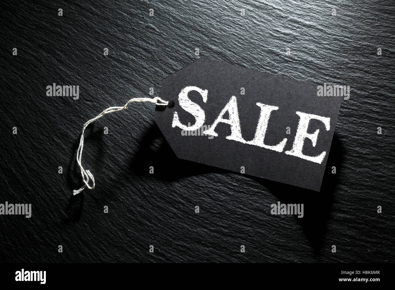Black Sale tag on slate background Stock Photo - Alamy