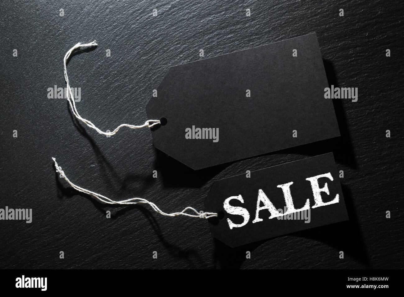Black Sale tag on slate background Stock Photo - Alamy