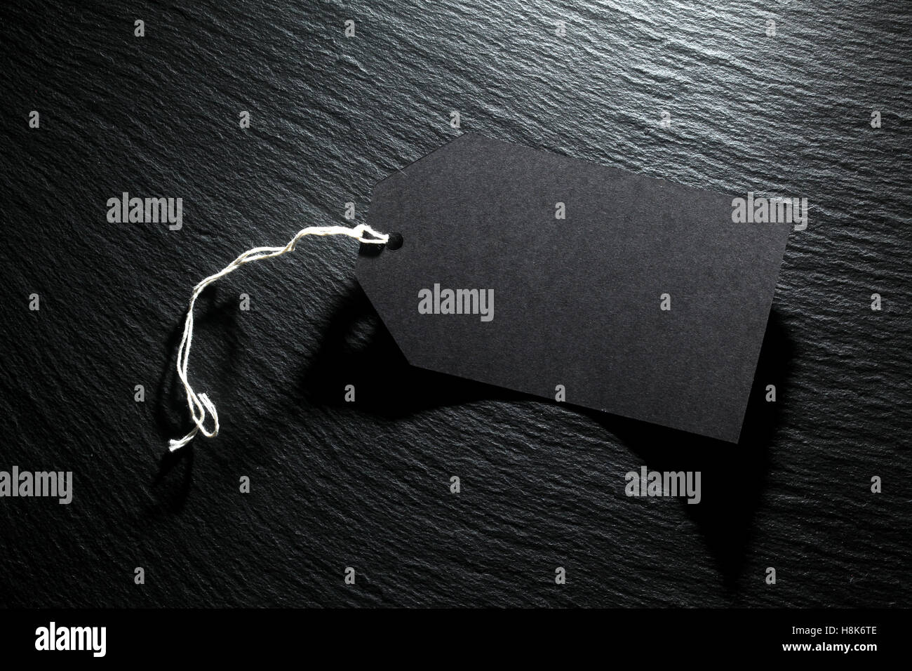 Blank black sale tag on dark slate background Stock Photo - Alamy