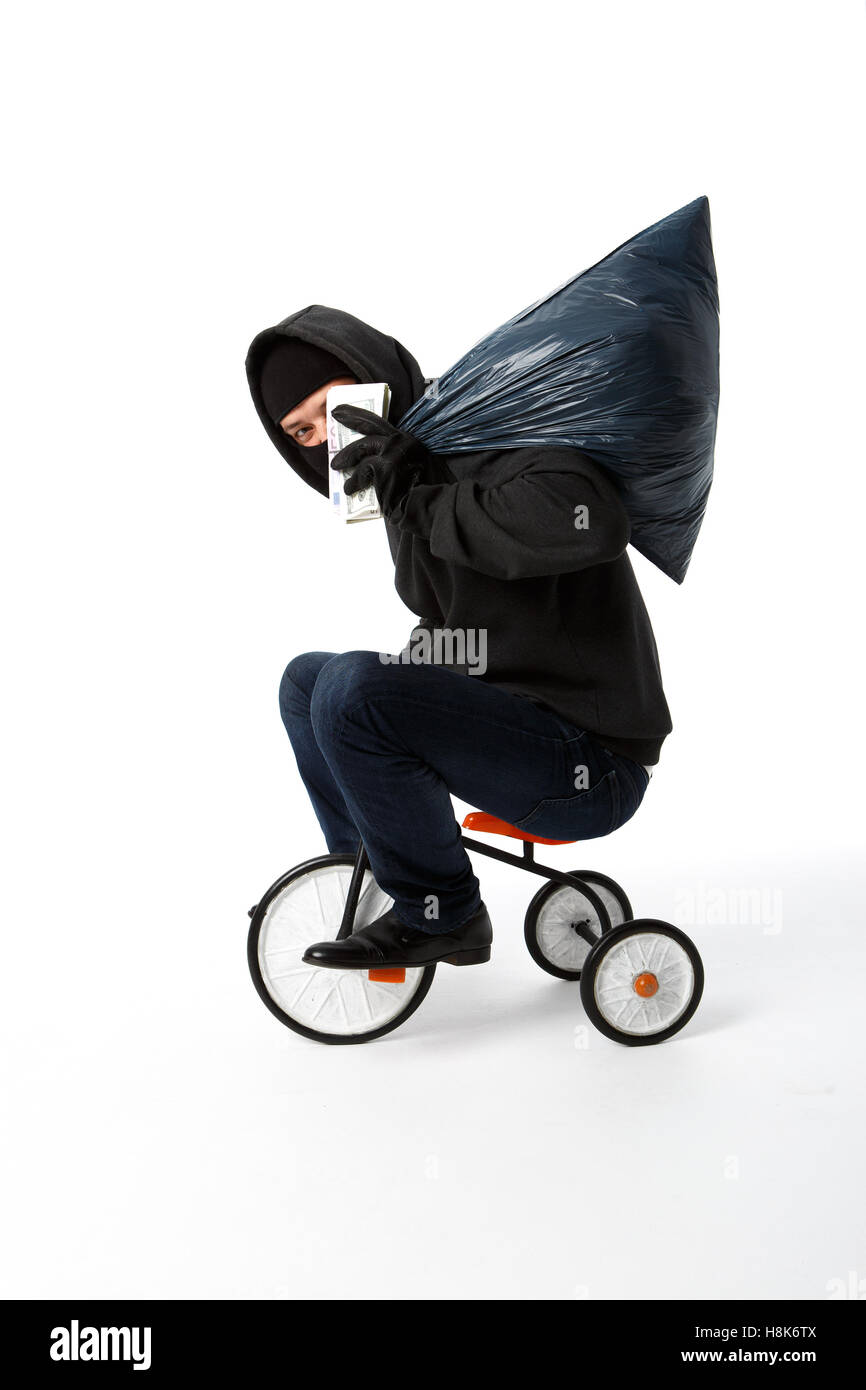 Robber goes on small bike Stock Photo - Alamy