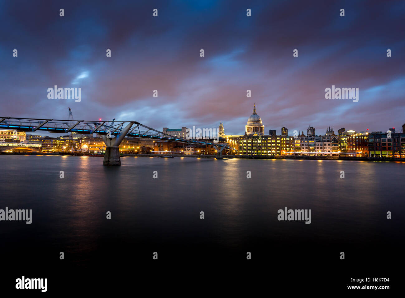 Millennium footbridge London with St Paul's Cathedral at dusk Stock ...
