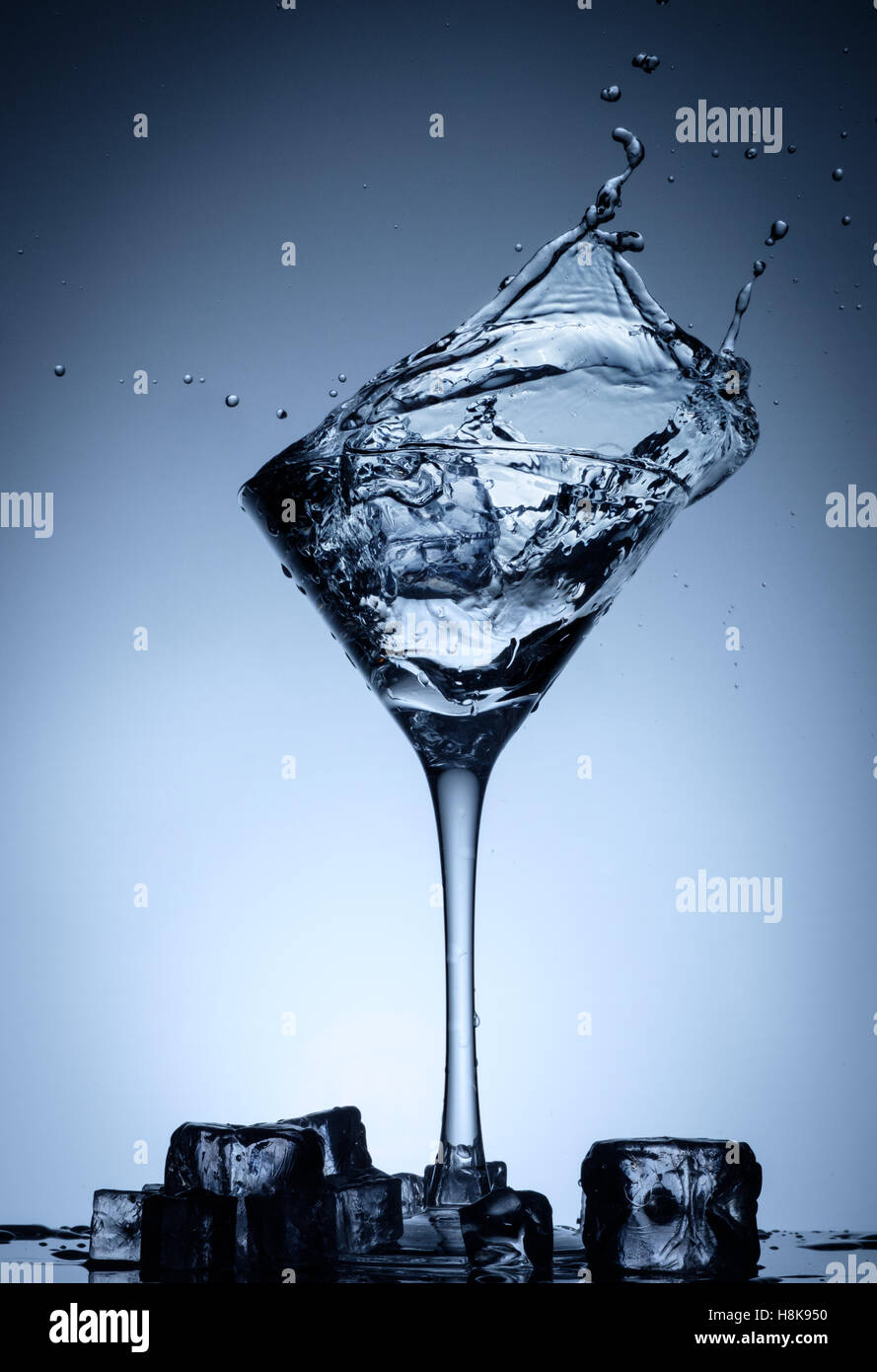 Water splash in glass with ice cubes Stock Photo - Alamy