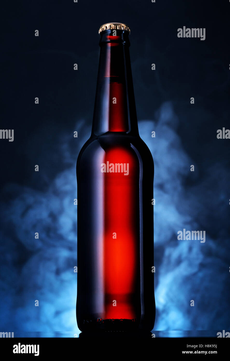 Bottle of beer on a dark background. Mysterious background with smoke ...