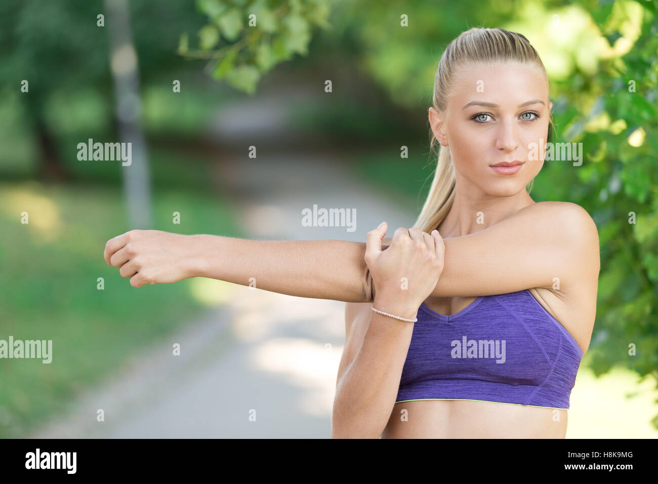Woman performs stretching before jogging Stock Photo - Alamy