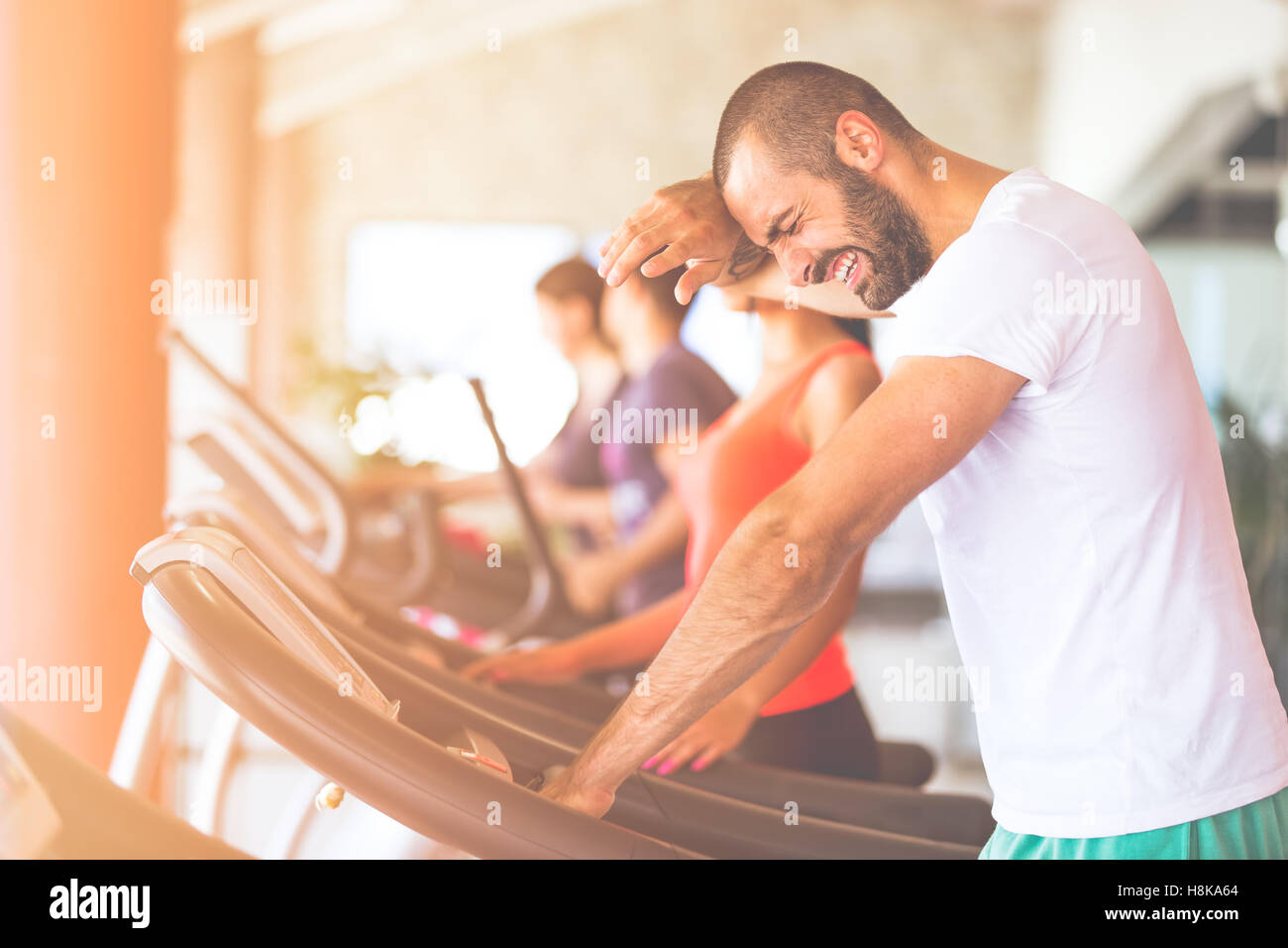 Man running in a modern gym on a treadmill Stock Photo - Alamy
