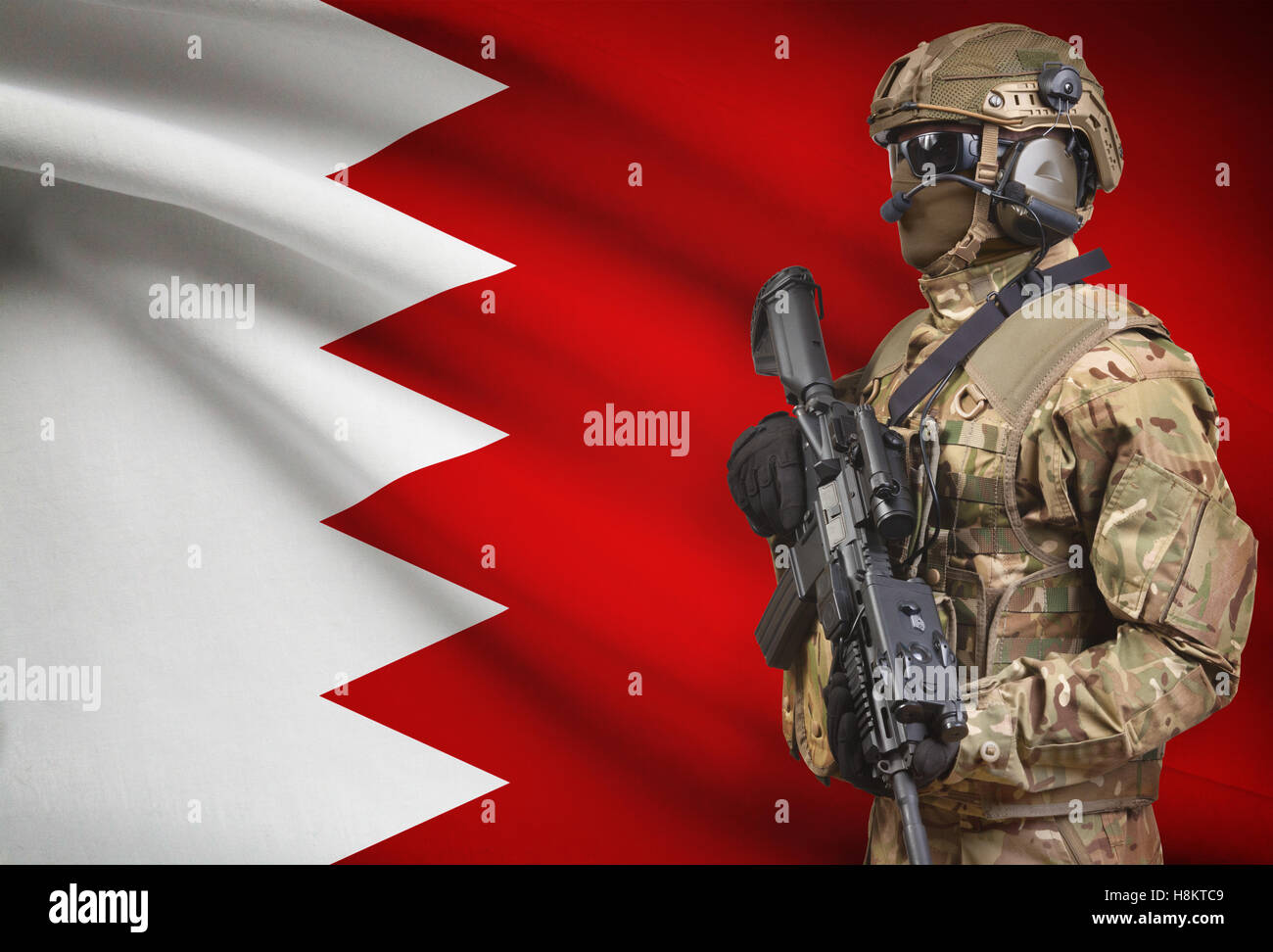 Soldier in helmet holding machine gun with national flag on background ...