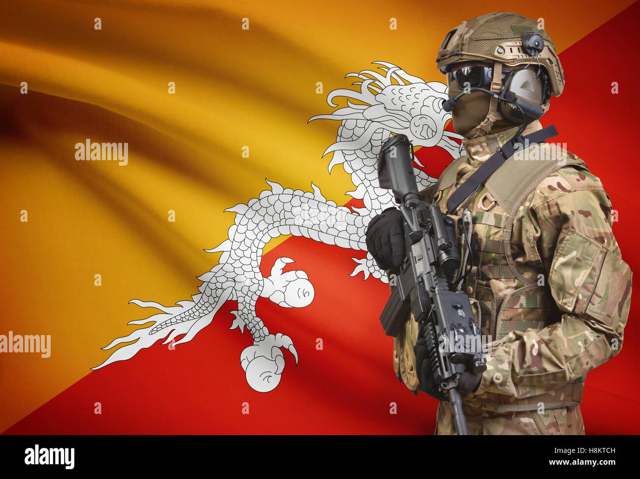 Soldier in helmet holding machine gun with national flag on background ...