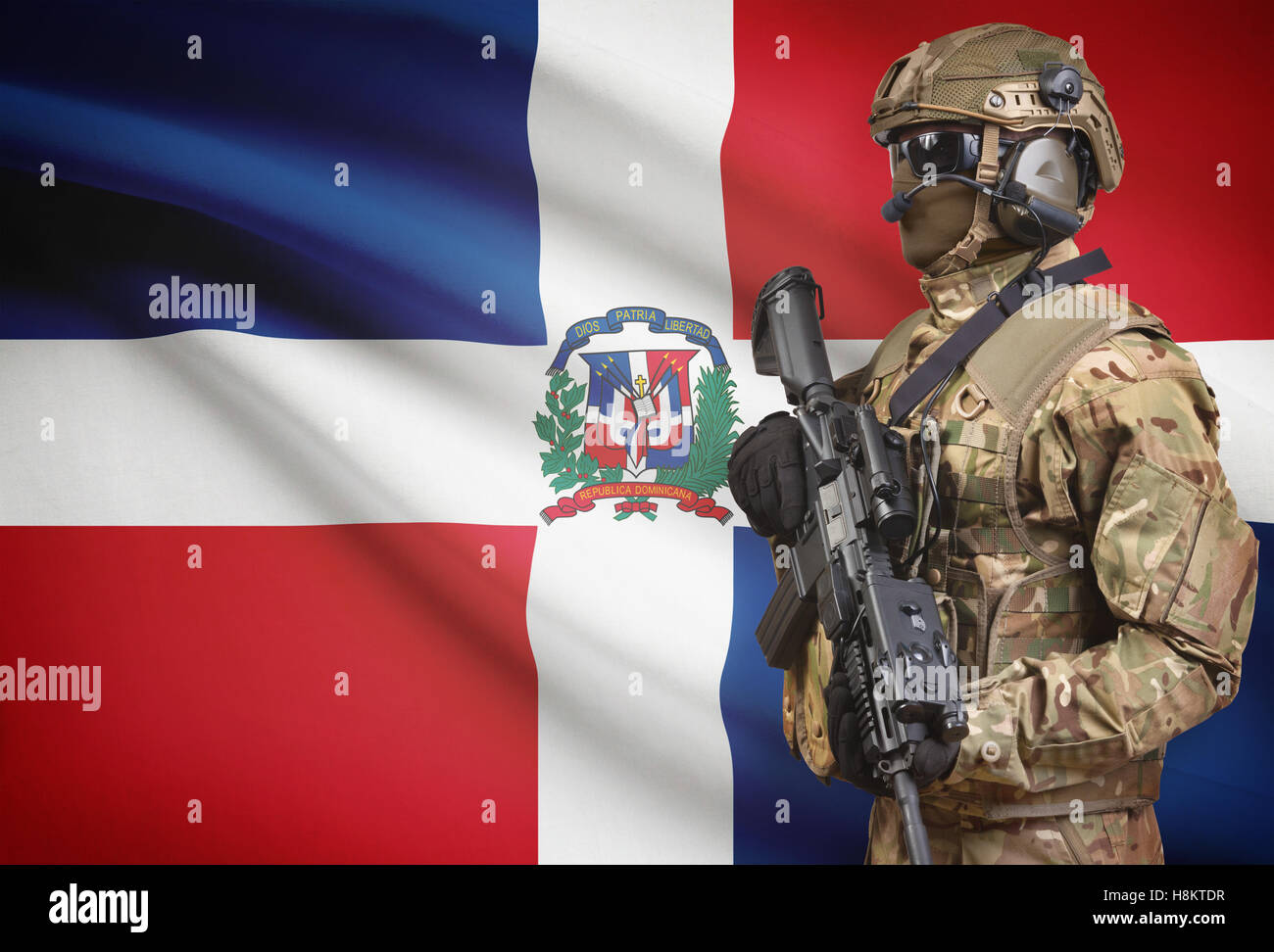 Soldier in helmet holding machine gun with national flag on background ...