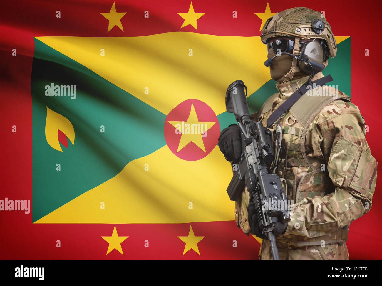 Soldier in helmet holding machine gun with national flag on background ...
