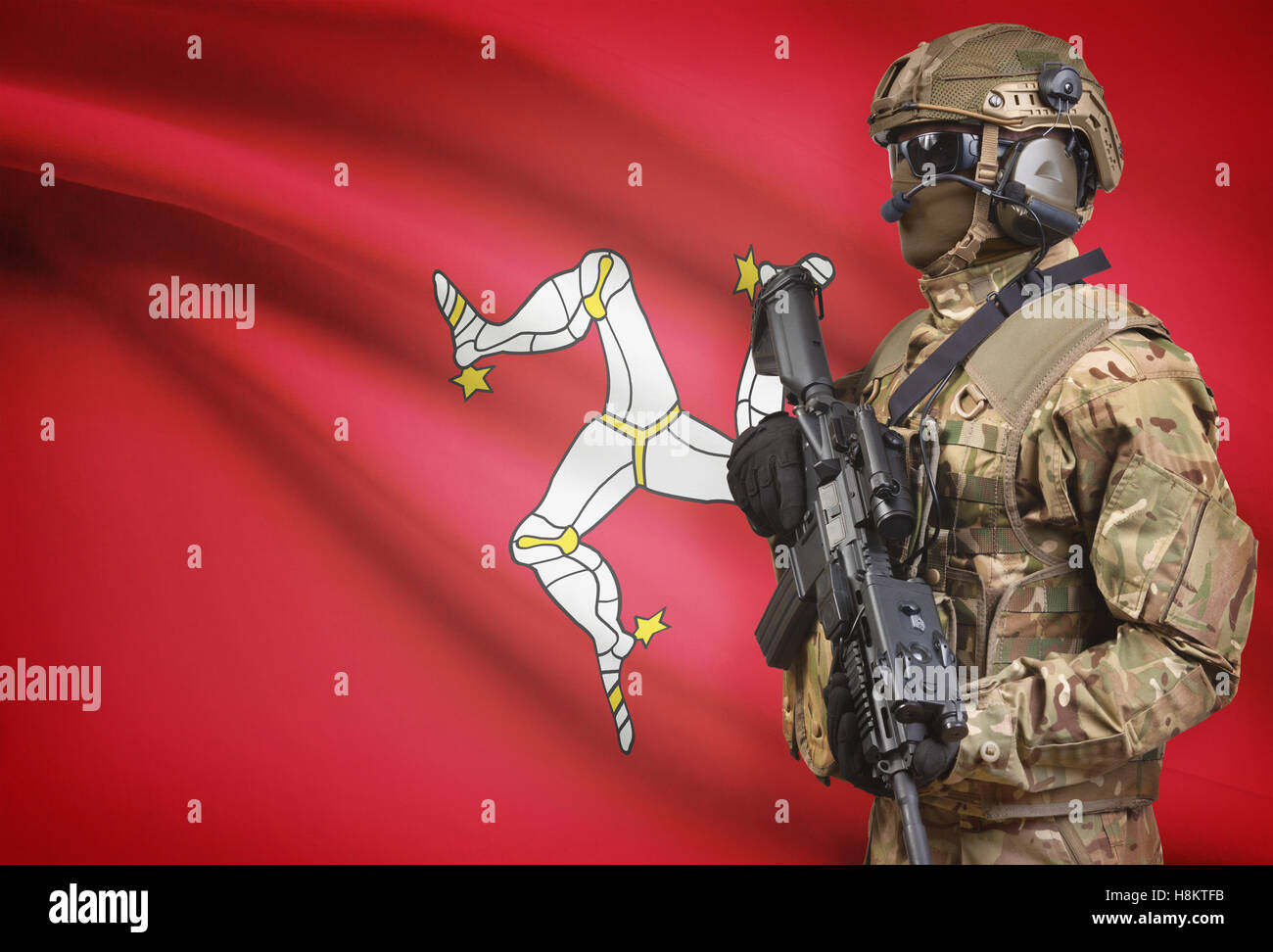 Soldier in helmet holding machine gun with national flag on background ...