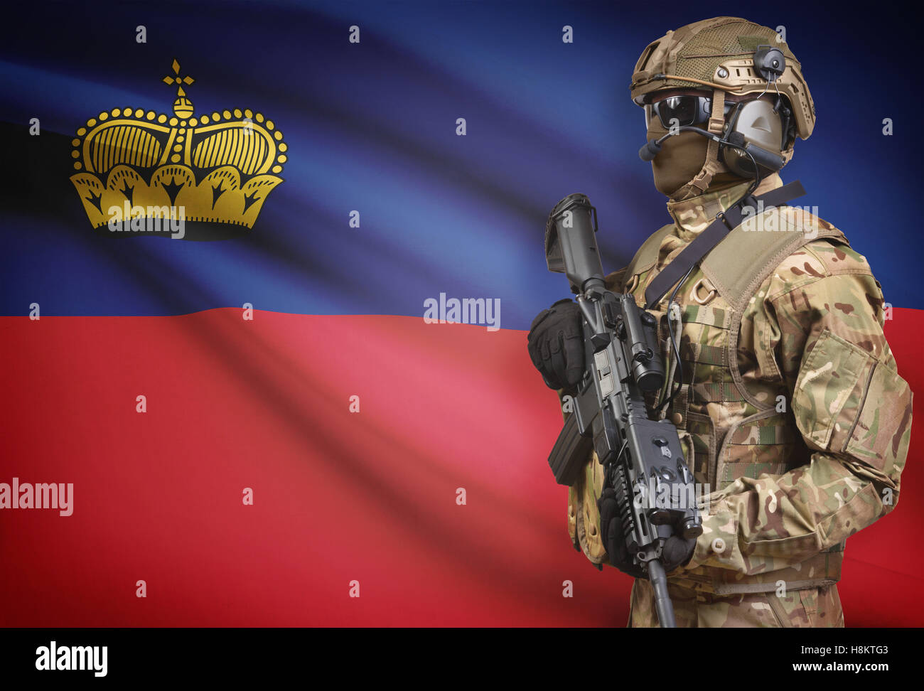 Soldier in helmet holding machine gun with national flag on background ...