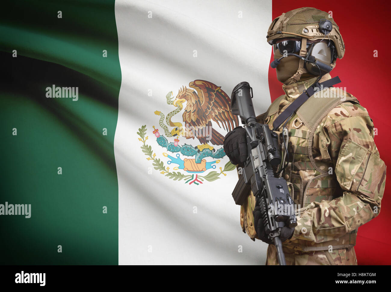 Soldier in helmet holding machine gun with national flag on background ...
