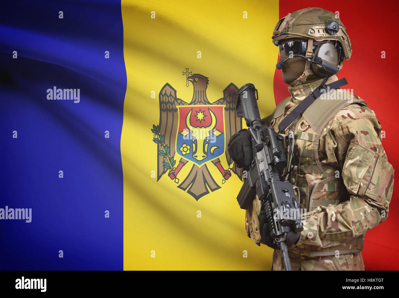 Soldier in helmet holding machine gun with national flag on background ...