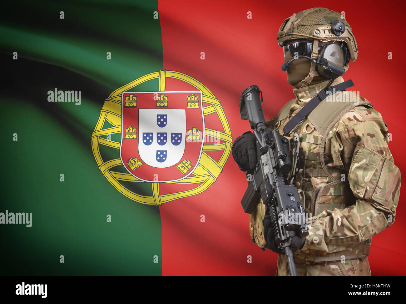 Soldier in helmet holding machine gun with national flag on background ...