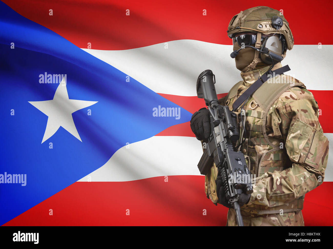 Soldier in helmet holding machine gun with national flag on background ...