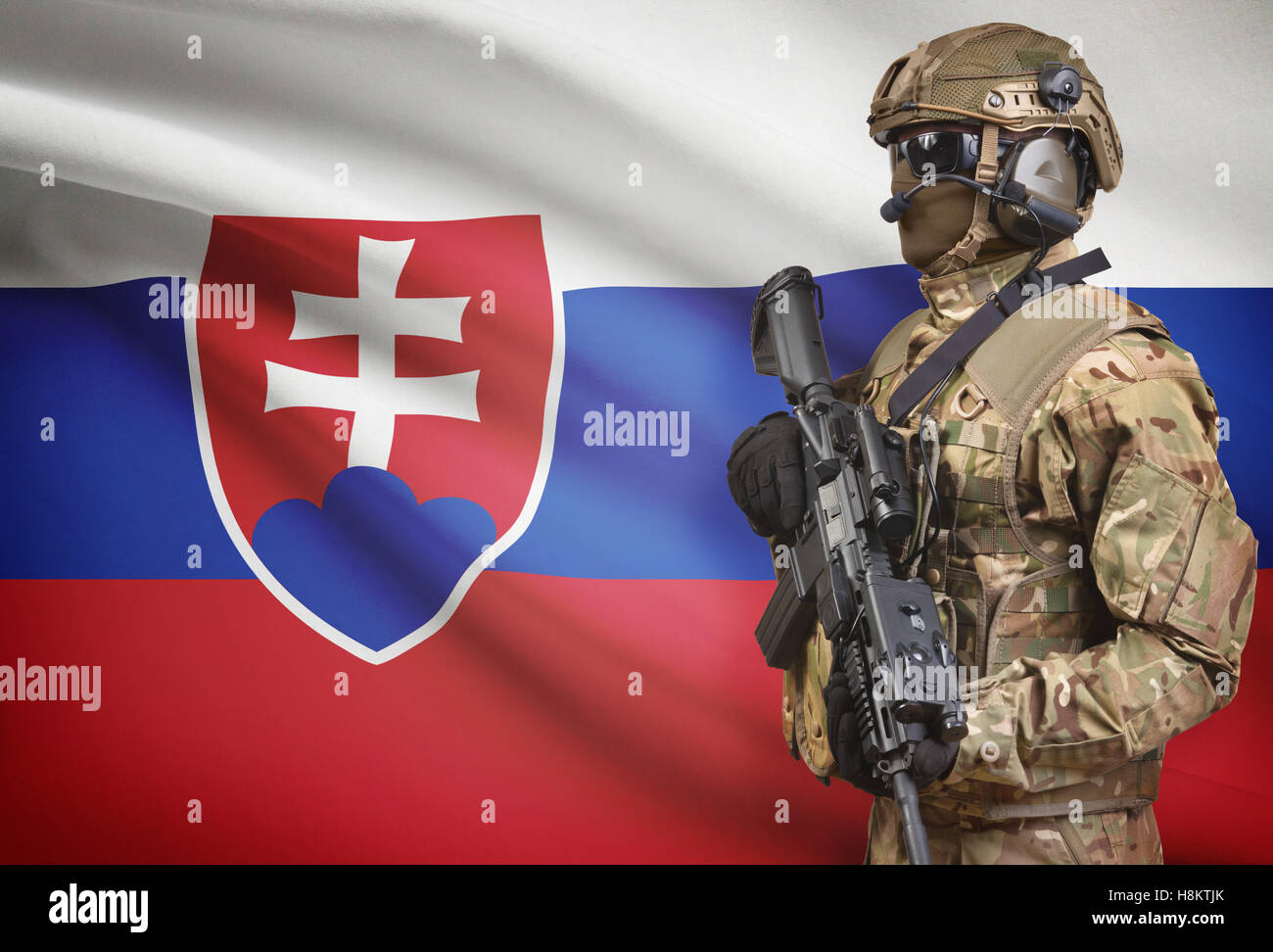 Soldier in helmet holding machine gun with national flag on background ...