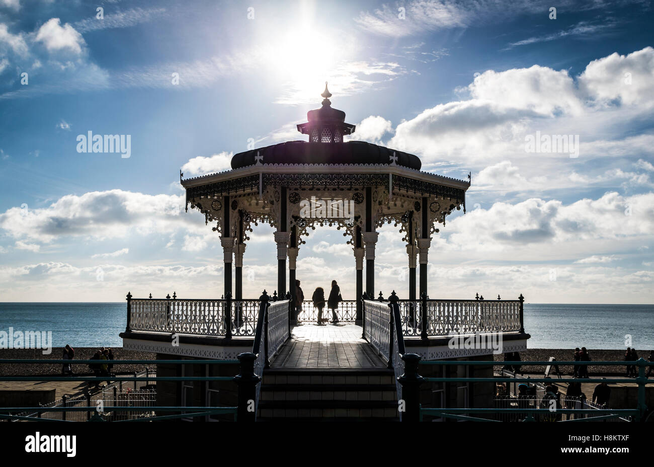 People silhouetted on The Bandstand, Hove, on the seafront. The ...