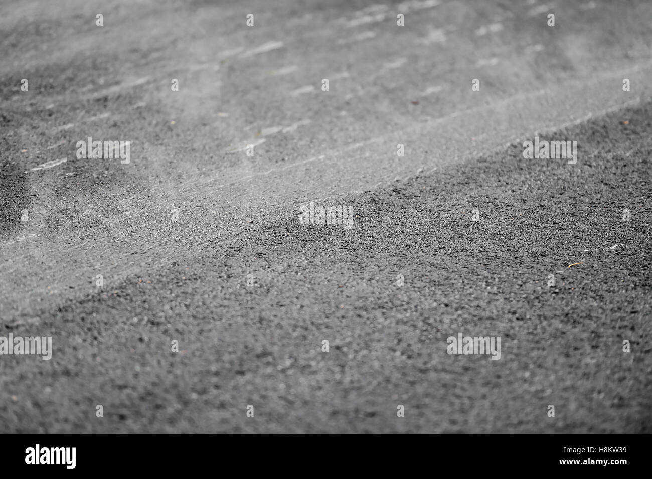 Steam coming out from asphalt after paving with a steel wheel roller ...