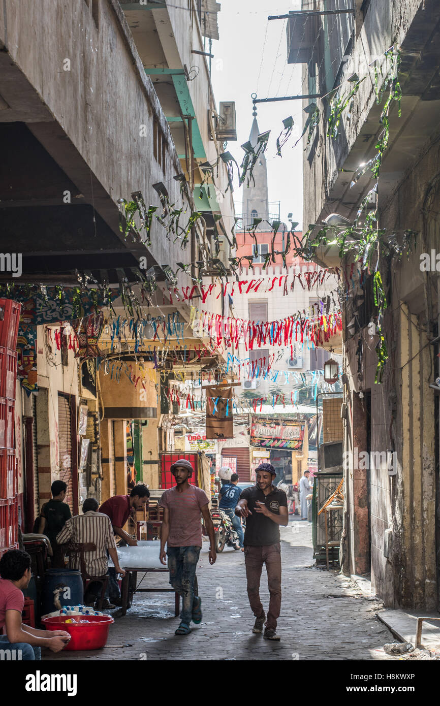 Cairo, Egypt. Men sitting in and walking through an alleyway in the ...
