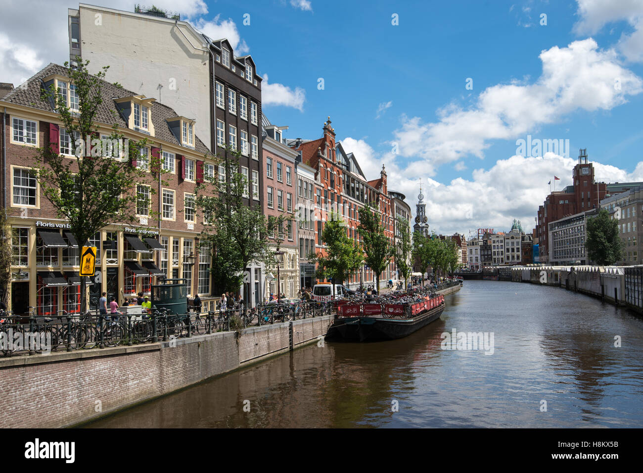 Amsterdam, Netherlands waterfront view of tourists walking along an ...