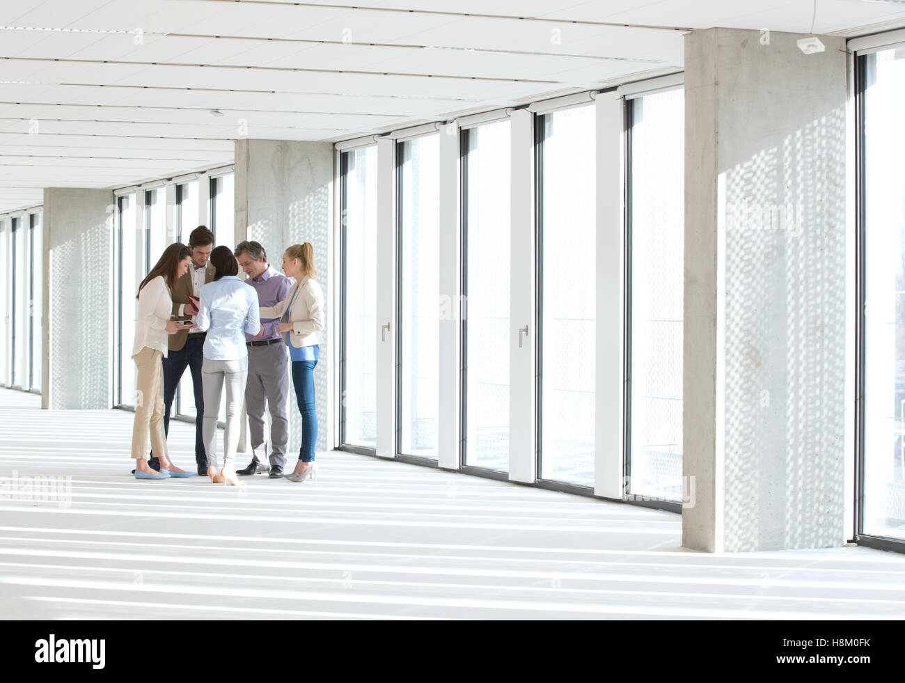 Full length of business people having discussion in empty office Stock ...