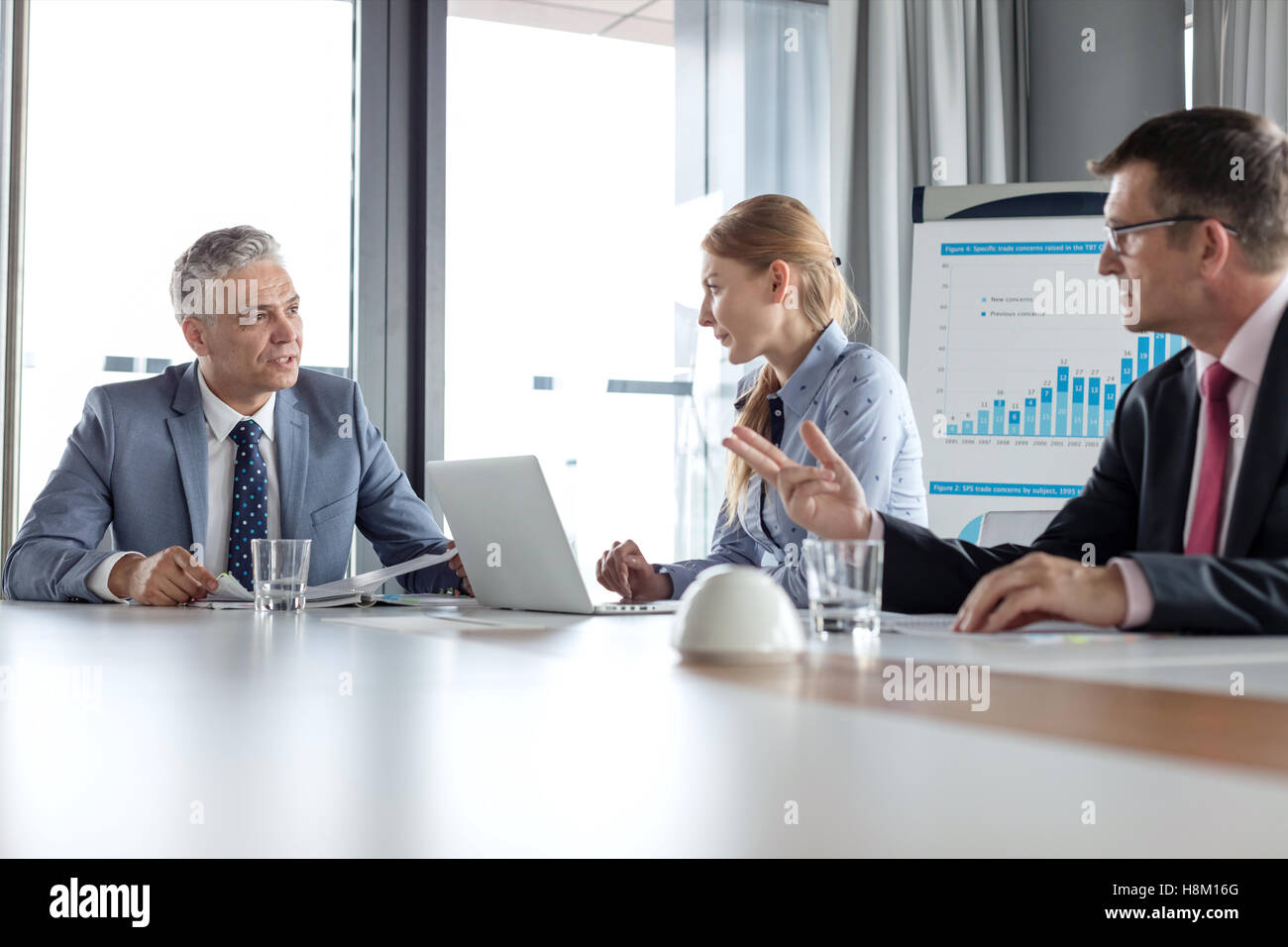 Business people having discussion at table in board room Stock Photo ...