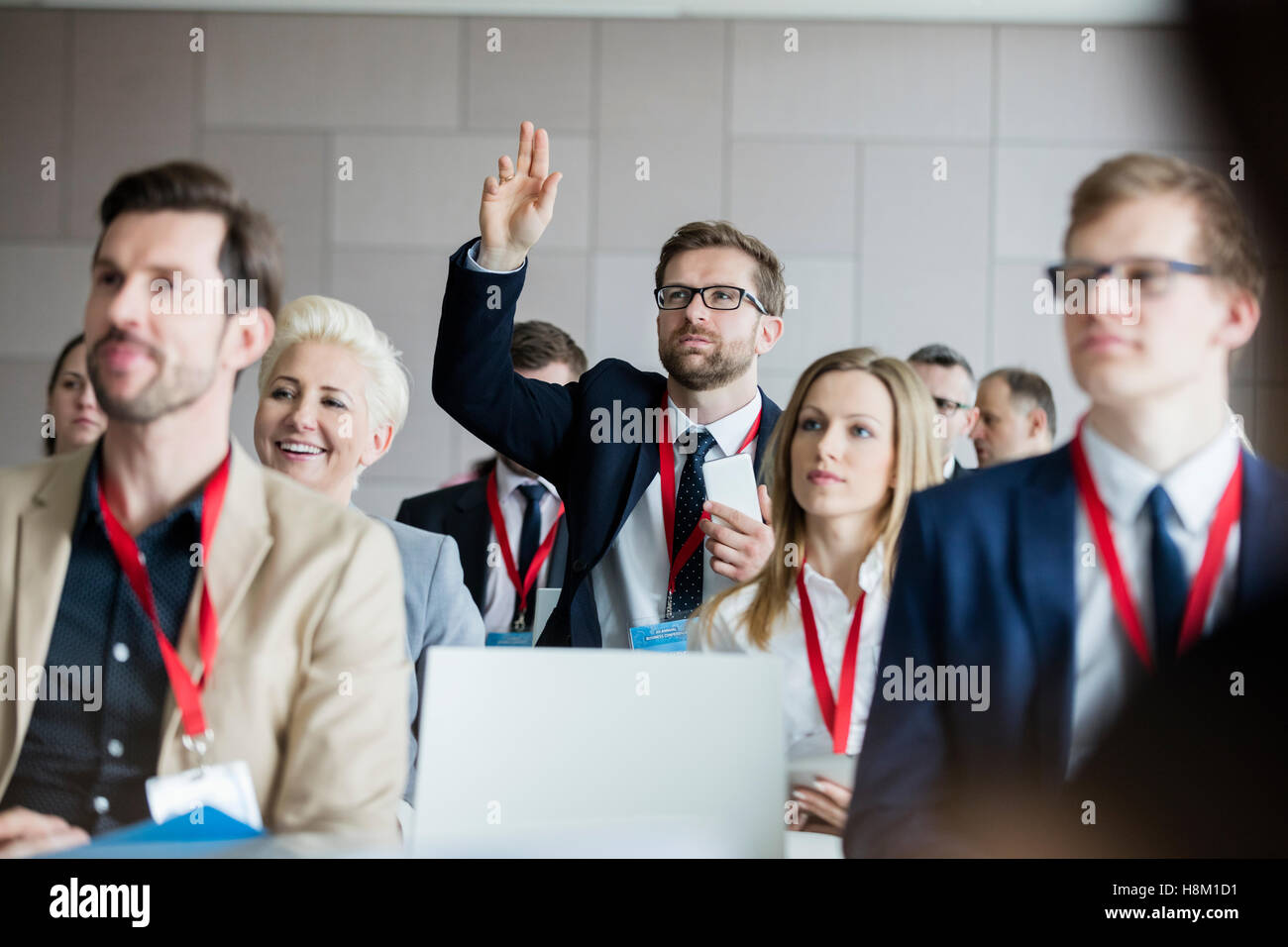 Businessman raising hand hi-res stock photography and images - Alamy