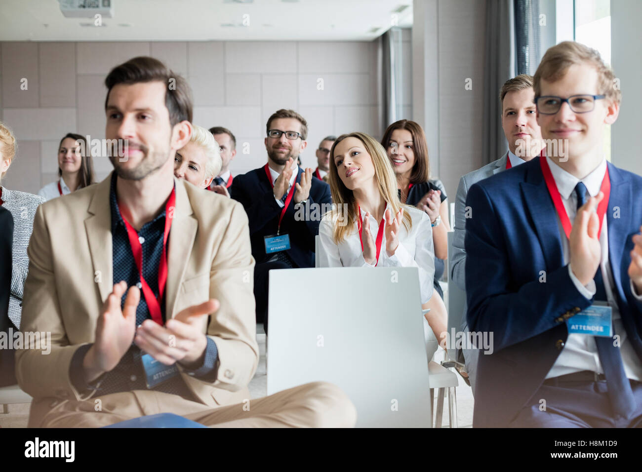 Confident business people applauding during seminar Stock Photo - Alamy