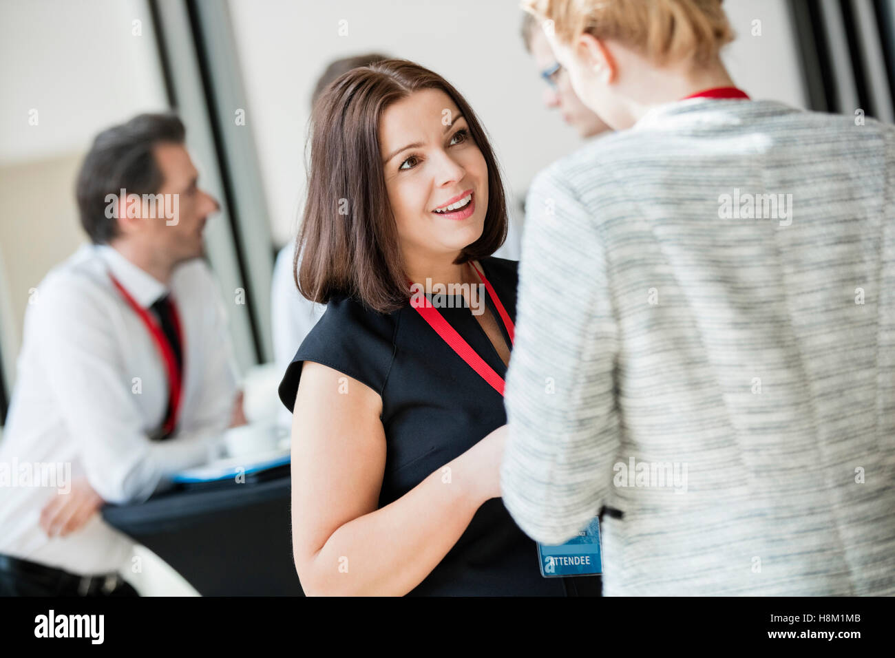 Businesswomen talking during coffee break at convention center Stock ...