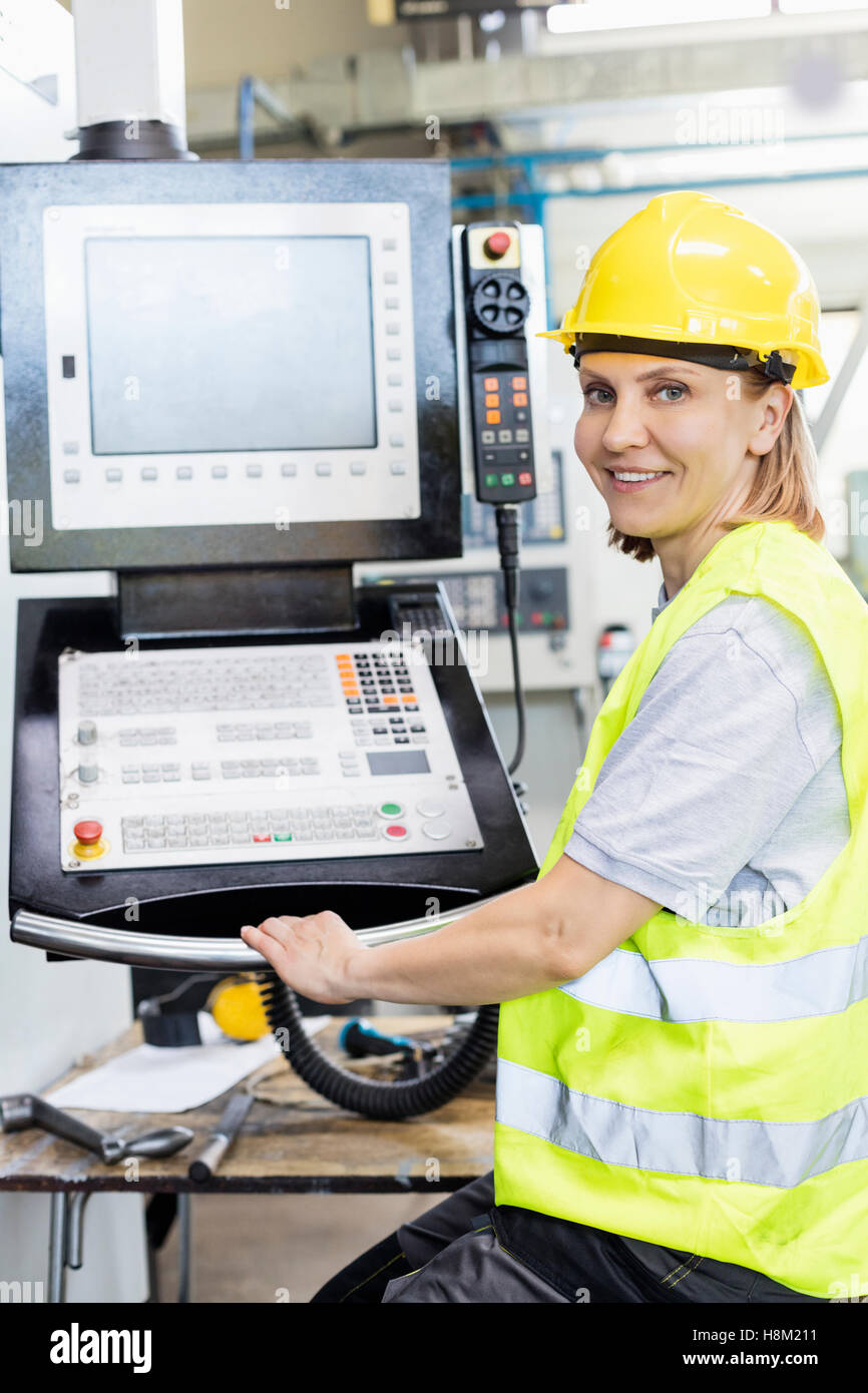 Worker operating machinery in manufacturing hi-res stock photography ...