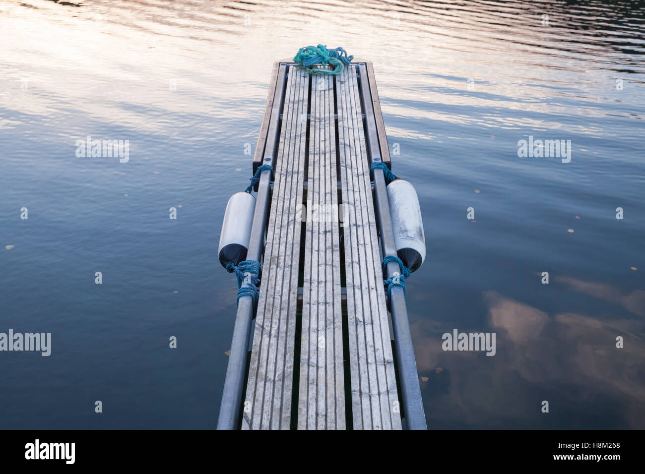 Perspective of small floating pier on still water, European marina ...