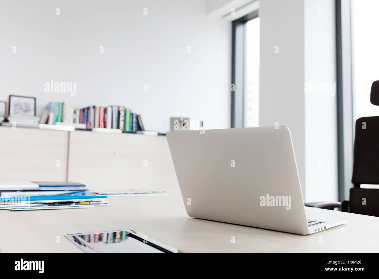 Laptop on desk in office Stock Photo - Alamy