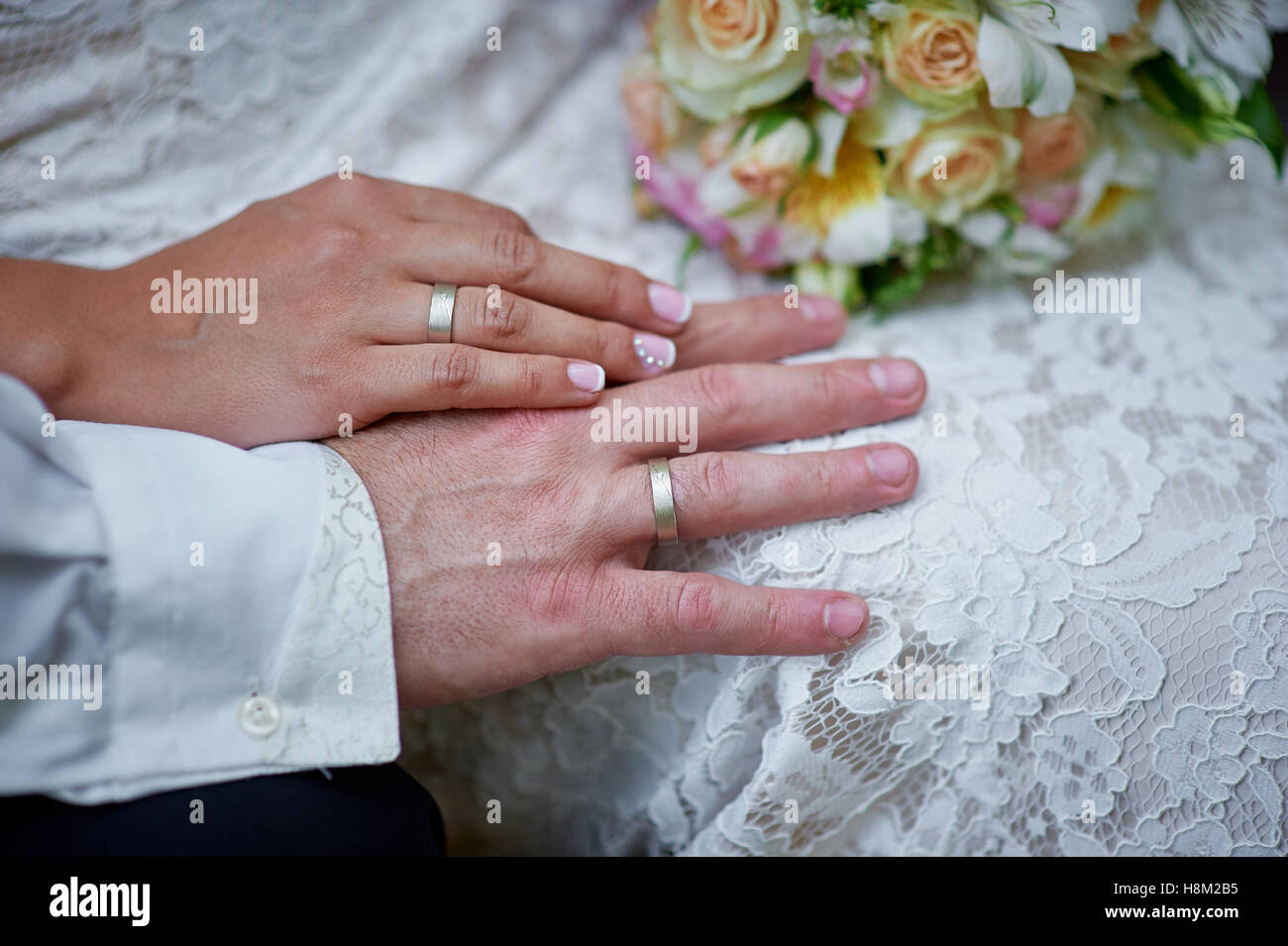 hands of the bride and groom with rings Stock Photo - Alamy