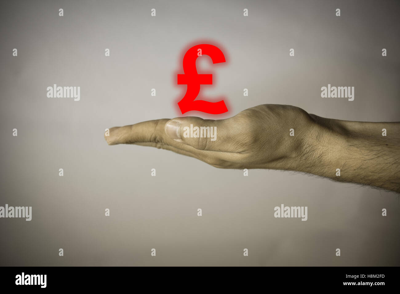 Human hand on vintage background with pound symbol Stock Photo - Alamy
