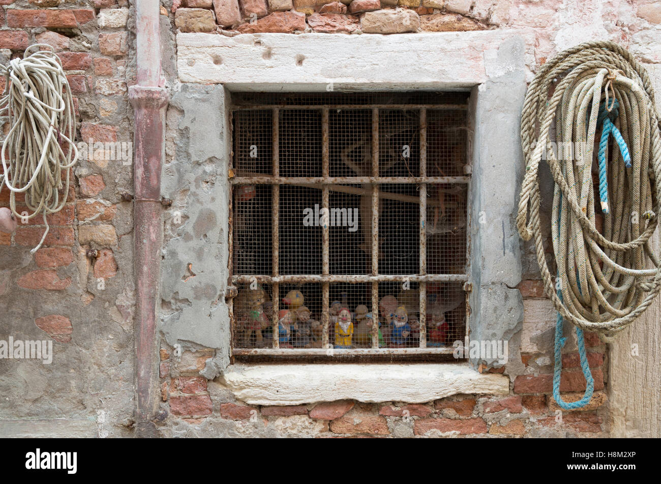 Window with ropes and figures, Venice Italy Stock Photo - Alamy