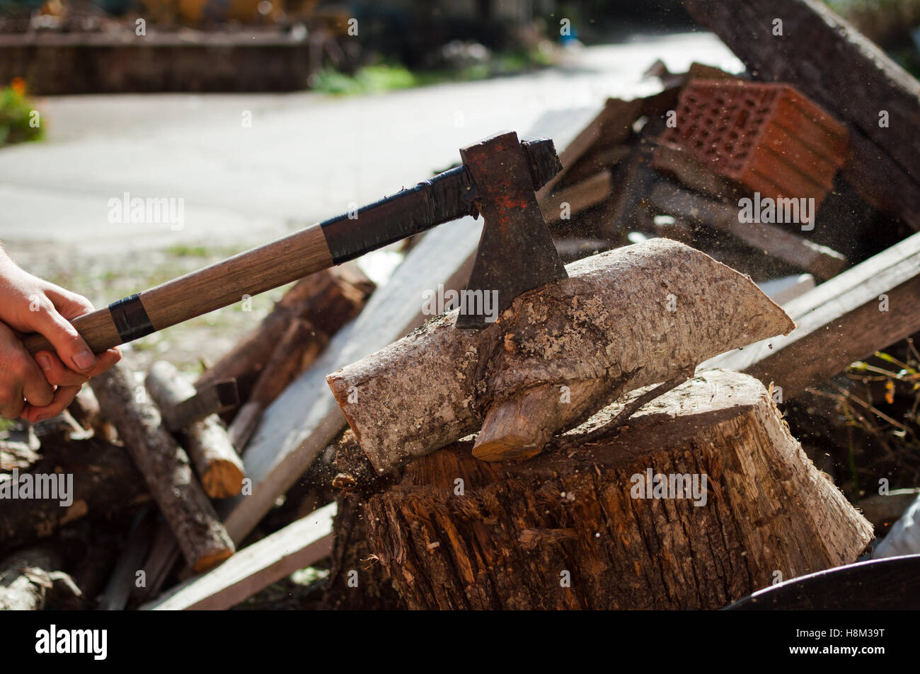 Ax striking wood Stock Photo - Alamy