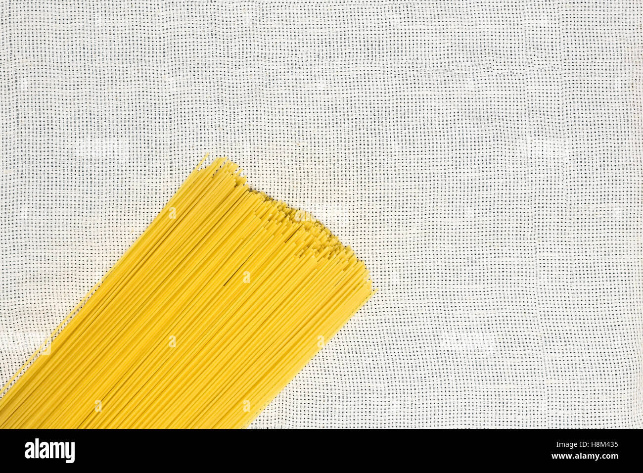 Raw spaghetti flat lay. Bunch of uncooked spaghetti top view on light ...