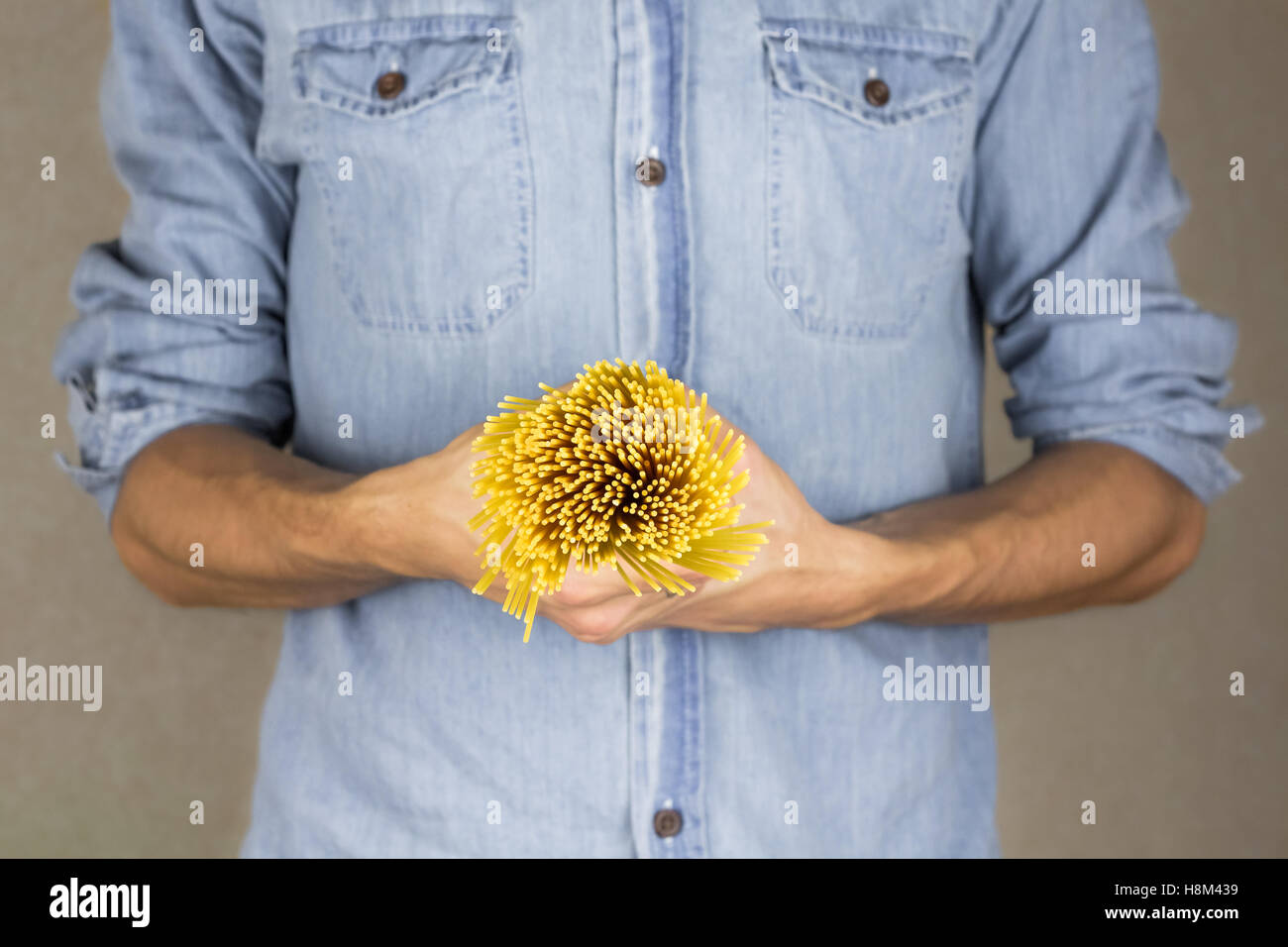 Bunch spaghetti in hands man hi-res stock photography and images - Alamy