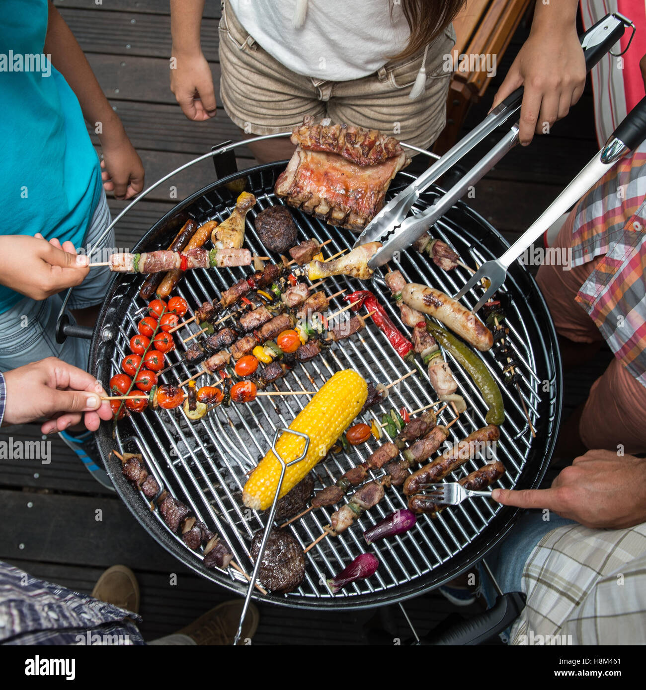 Top view of friend hands serving food at barbecue garden party, France ...