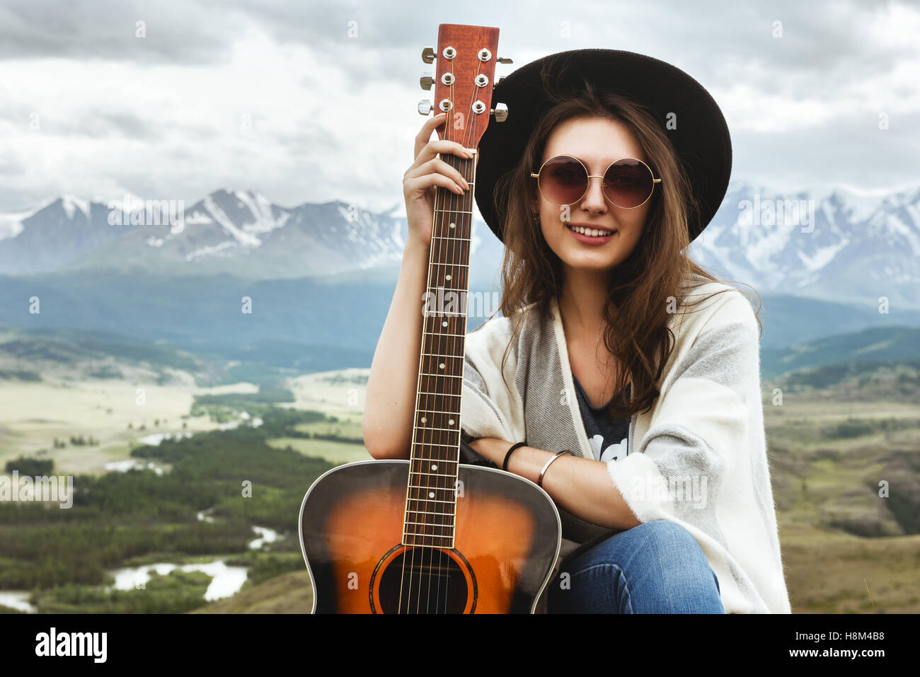 Beautiful girl with guitar mountains Stock Photo - Alamy