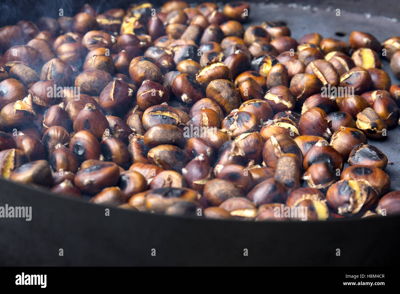 Organic Brown Chestnuts Roasting over a hot fire Stock Photo - Alamy