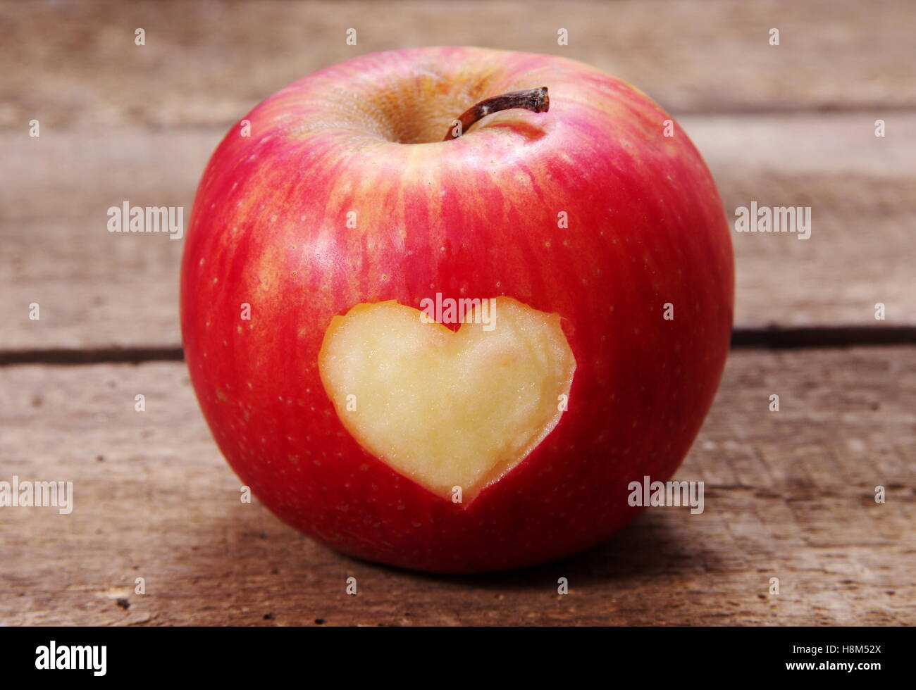 apple with heart on table Stock Photo - Alamy