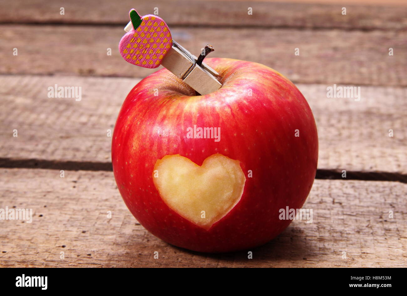 apple with heart on table Stock Photo - Alamy