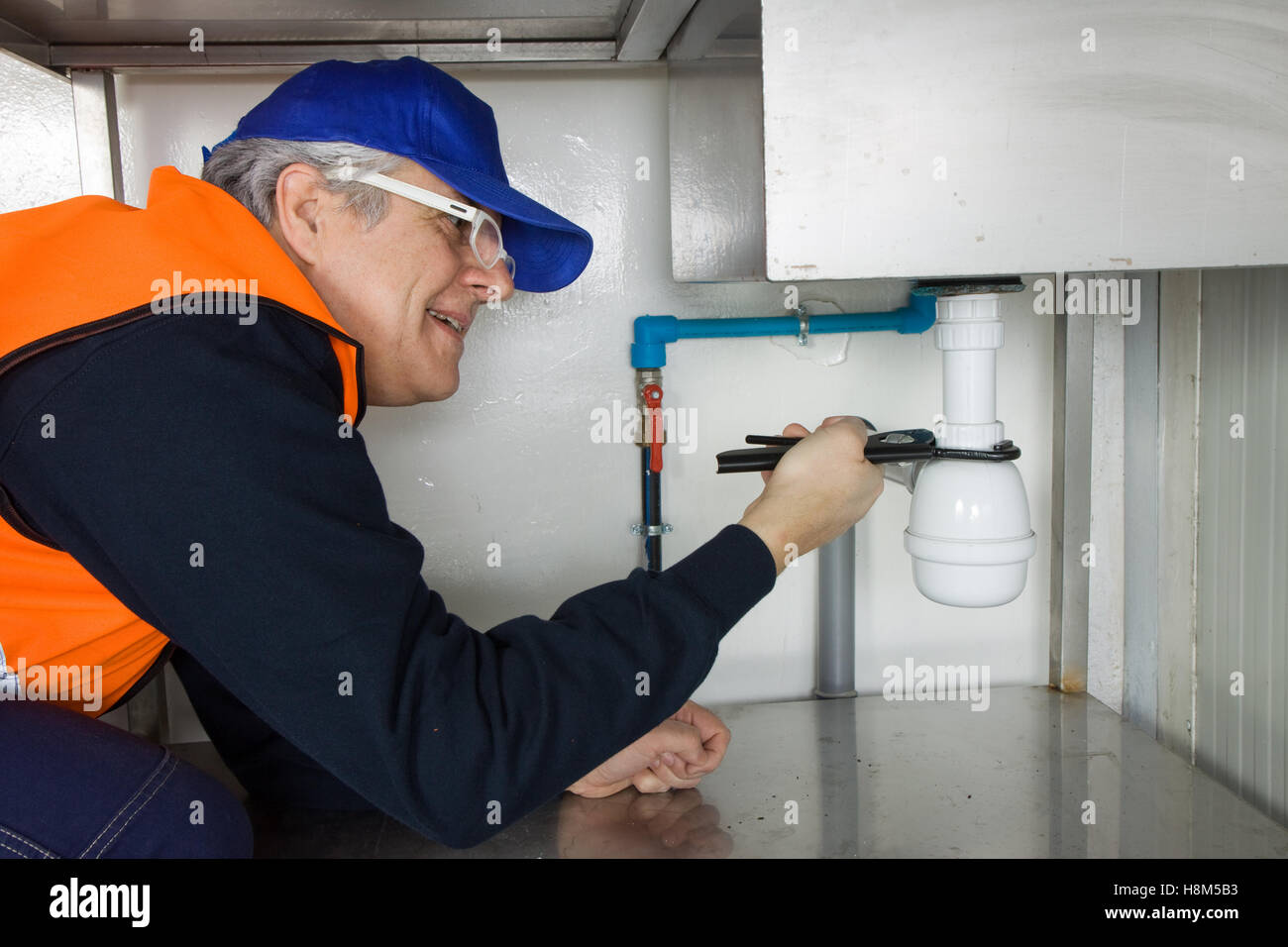 plumber at work in a building site Stock Photo - Alamy