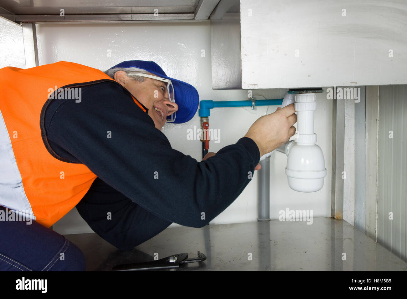 plumber at work in a building site Stock Photo - Alamy