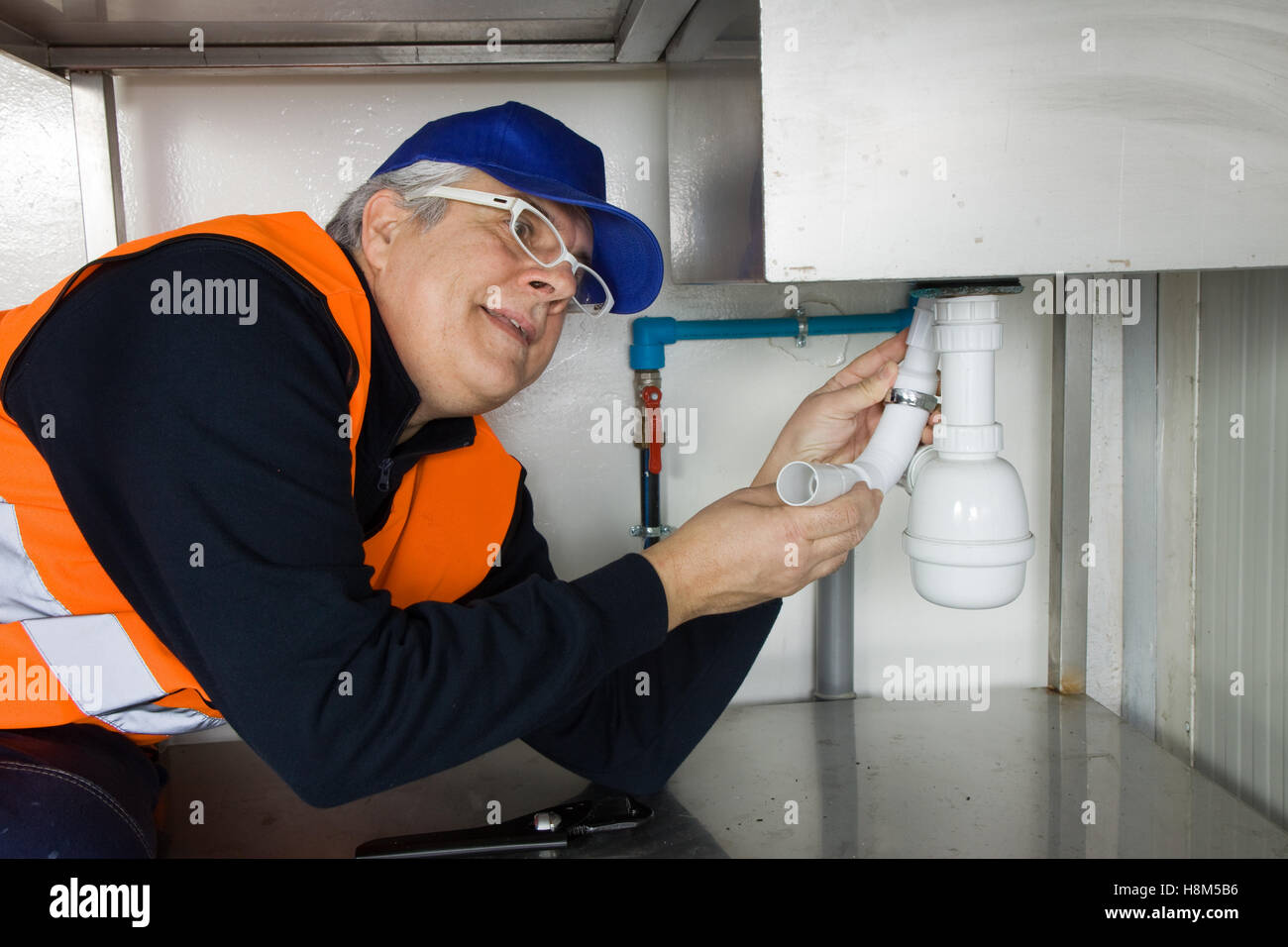 plumber at work in a building site Stock Photo - Alamy