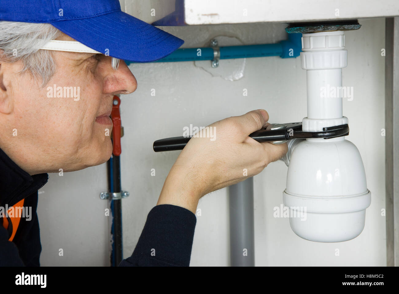 plumber at work in a building site Stock Photo - Alamy